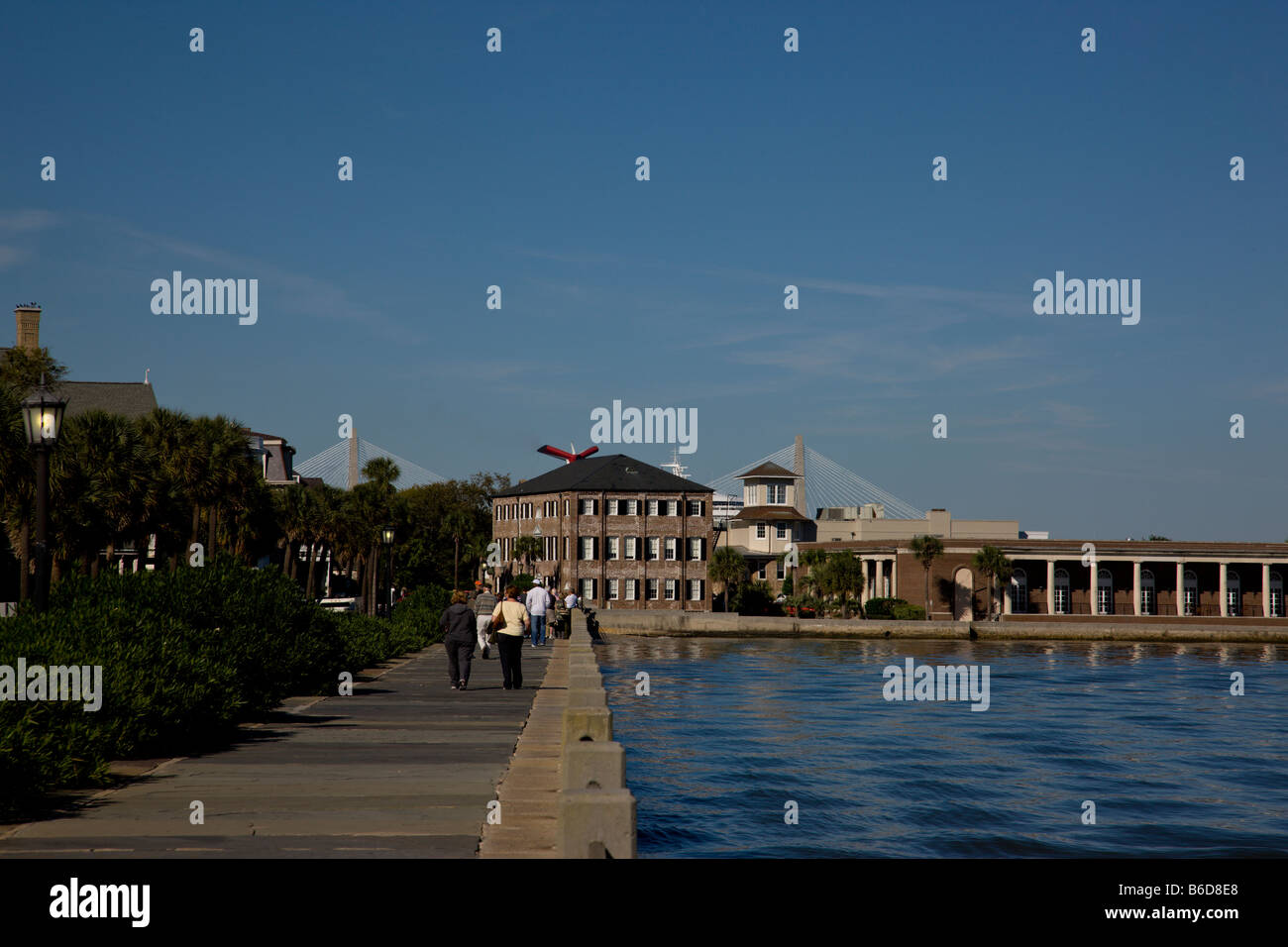 Pedestrians walk atop the sea wall at "The Battery" in Charleston ...