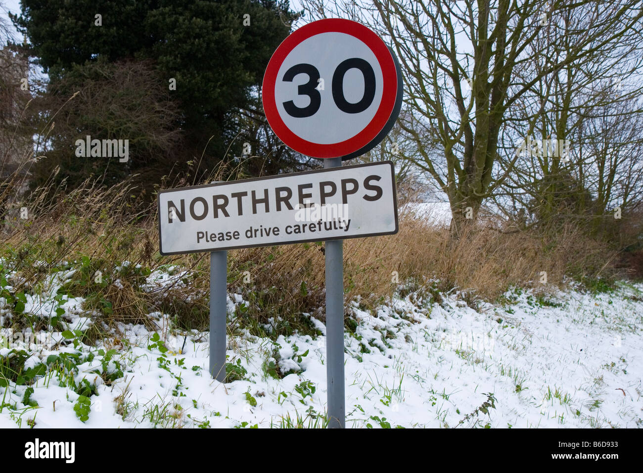 Village road sign Northrepps Norfolk Winter one of two depicting summer ...