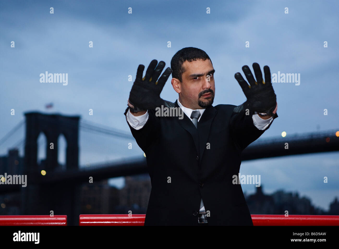 A man holds up his gloved hands under the Brooklyn Bridge Stock Photo ...