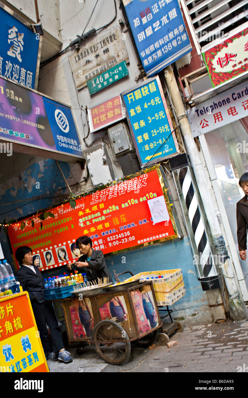 CHINA SHANGHAI Street scene with colorful signs in both Mandarin ...