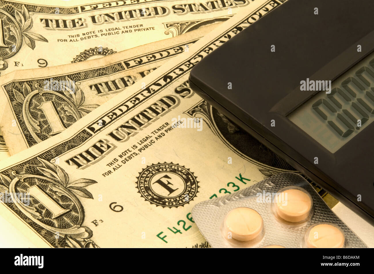 Calculators and headache tablets are on the money Stock Photo - Alamy