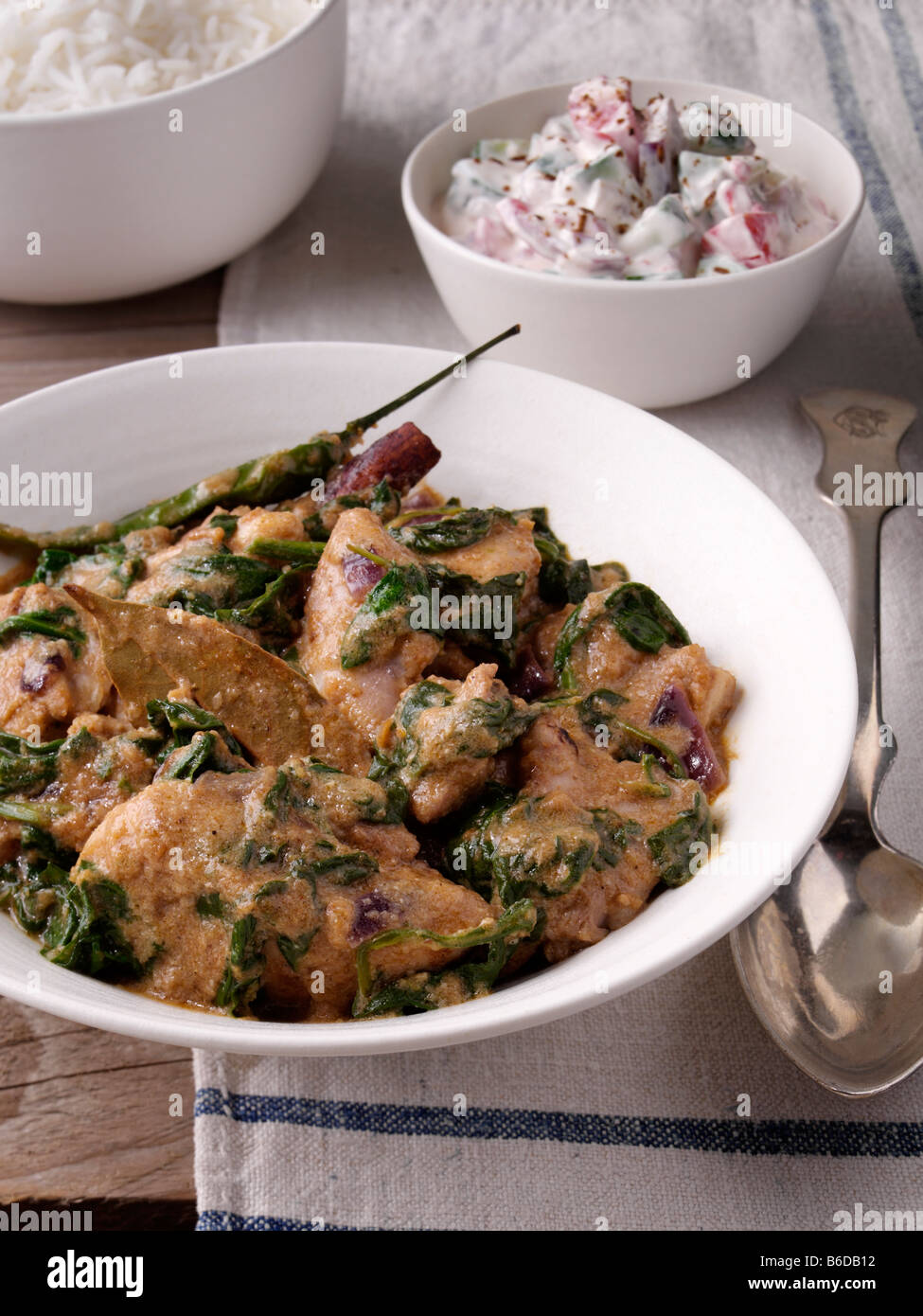 Chicken and spinach curry with raita and rice Stock Photo - Alamy