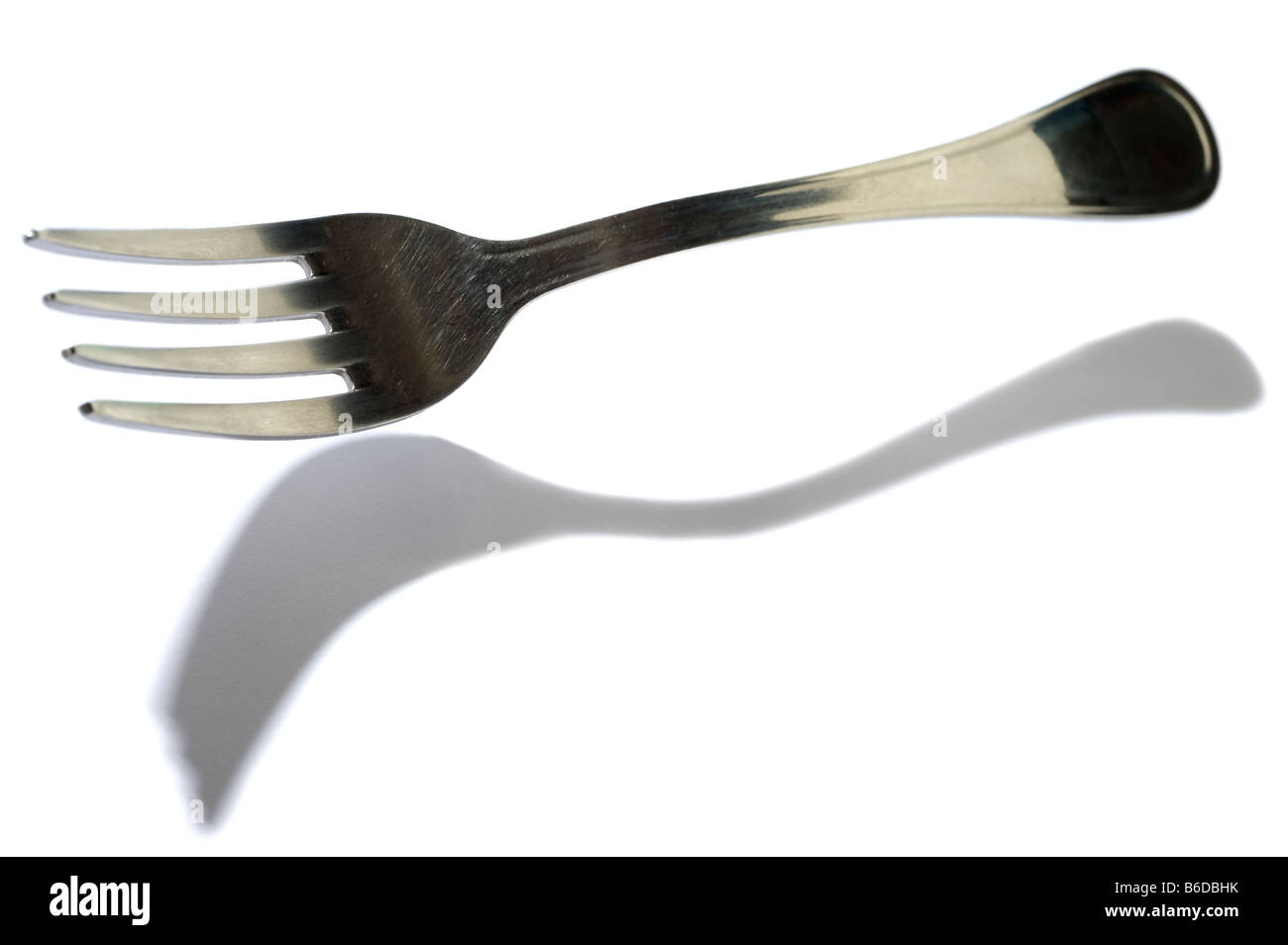 Cutlery fork and shadow Stock Photo - Alamy