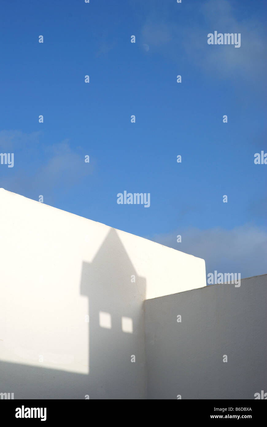 Shadow of chimney on whitewashed wall. Lanzarote island. Canary Islands ...