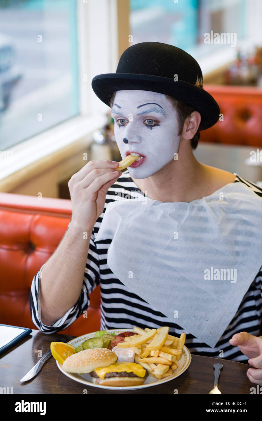 Young man, painted face, mime, smiling Stock Photo - Alamy