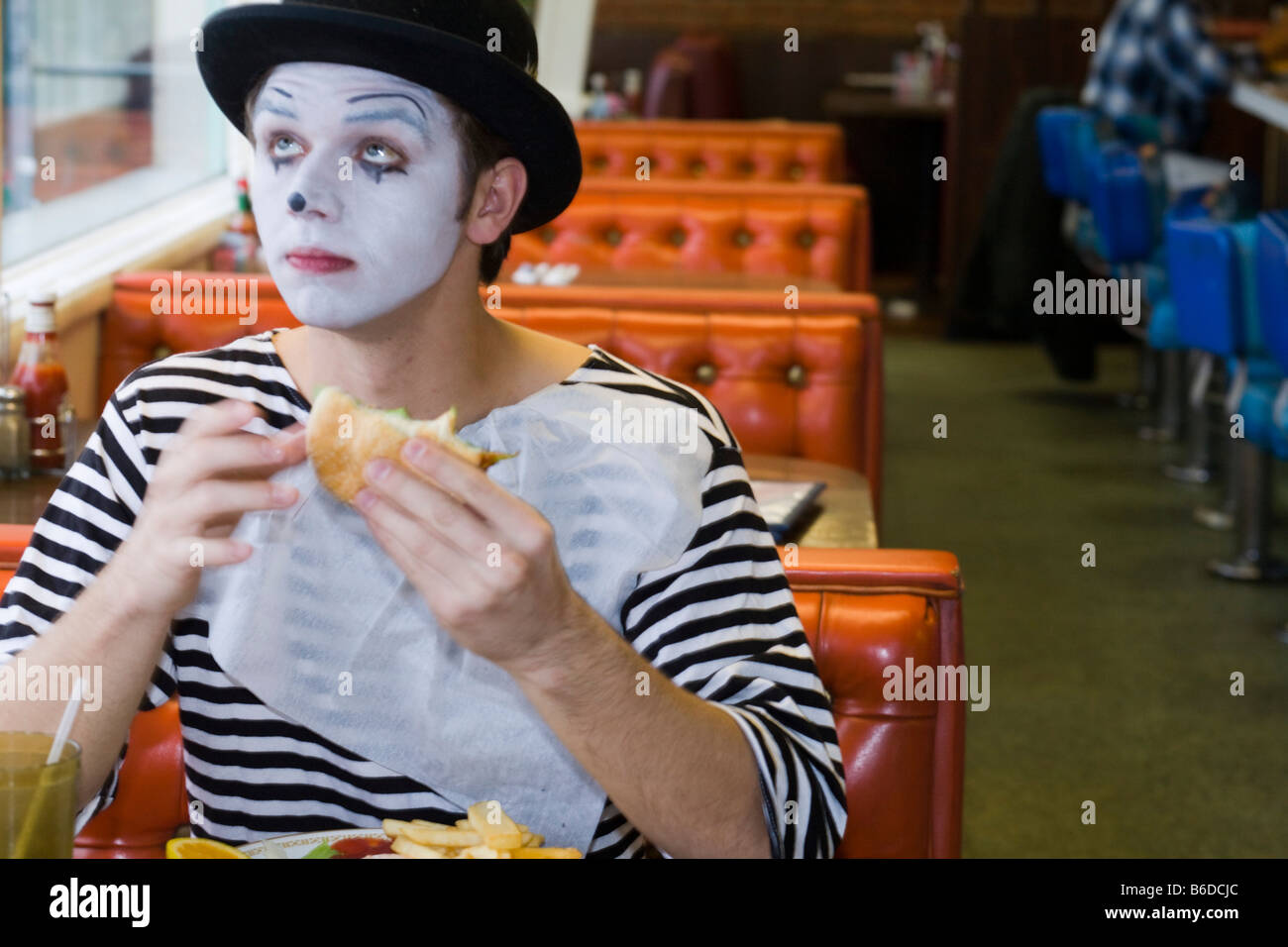 Young man, painted face, mime, smiling Stock Photo - Alamy