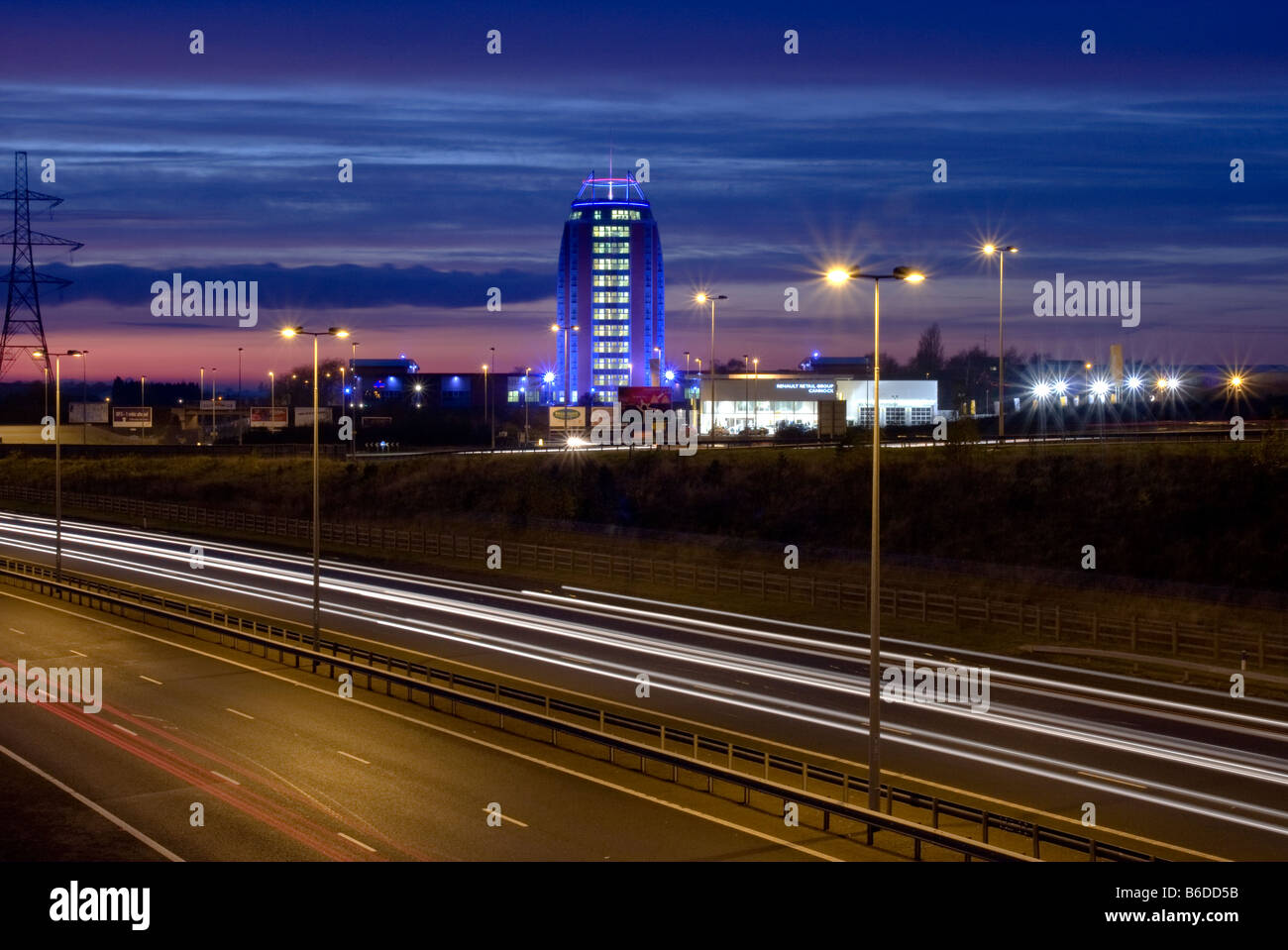 night shot of cars travelling along the "m6 toll road" with a tall ...
