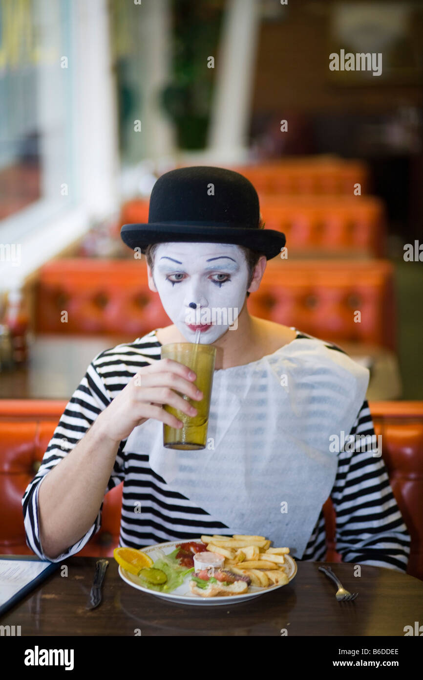 Young man, painted face, mime, smiling Stock Photo - Alamy