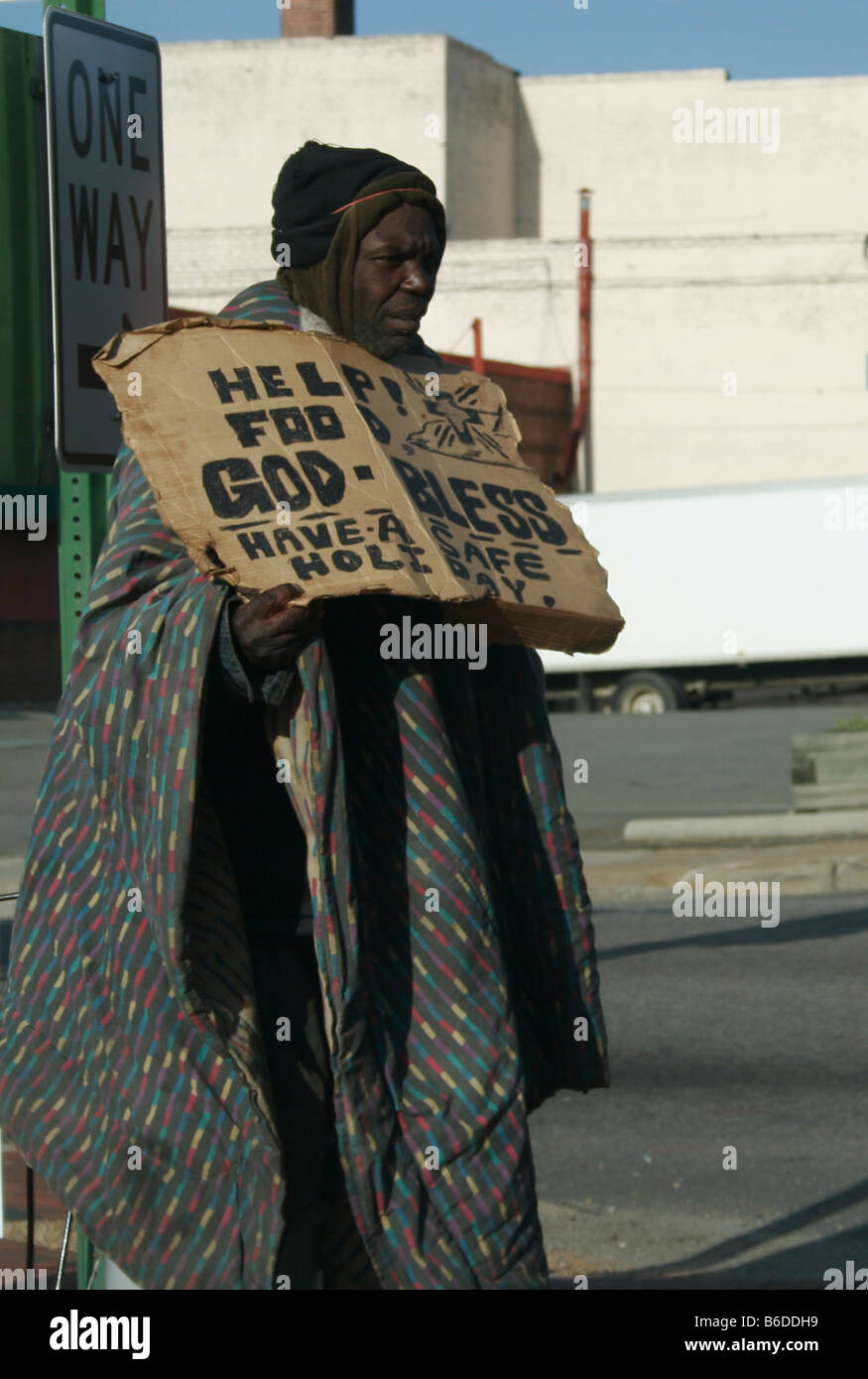 Homeless man wishing people a safe christmas Stock Photo - Alamy