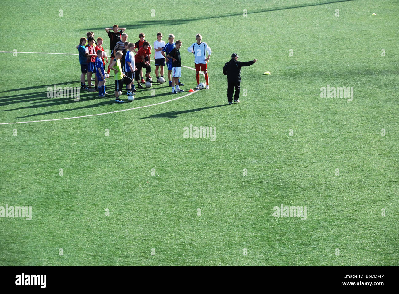 sports team and coach on the football field Stock Photo - Alamy