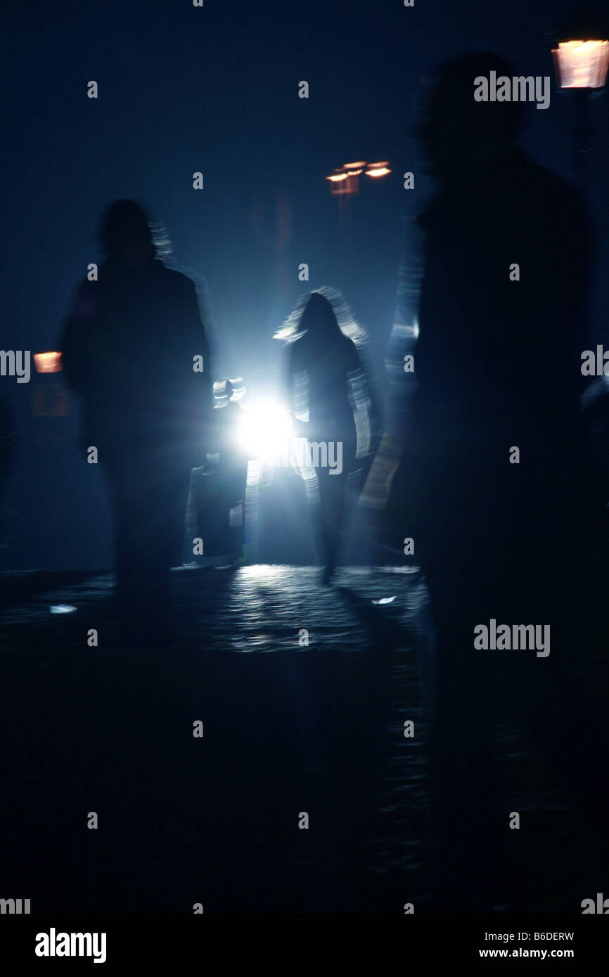 people walking in dark street alley at night Stock Photo - Alamy
