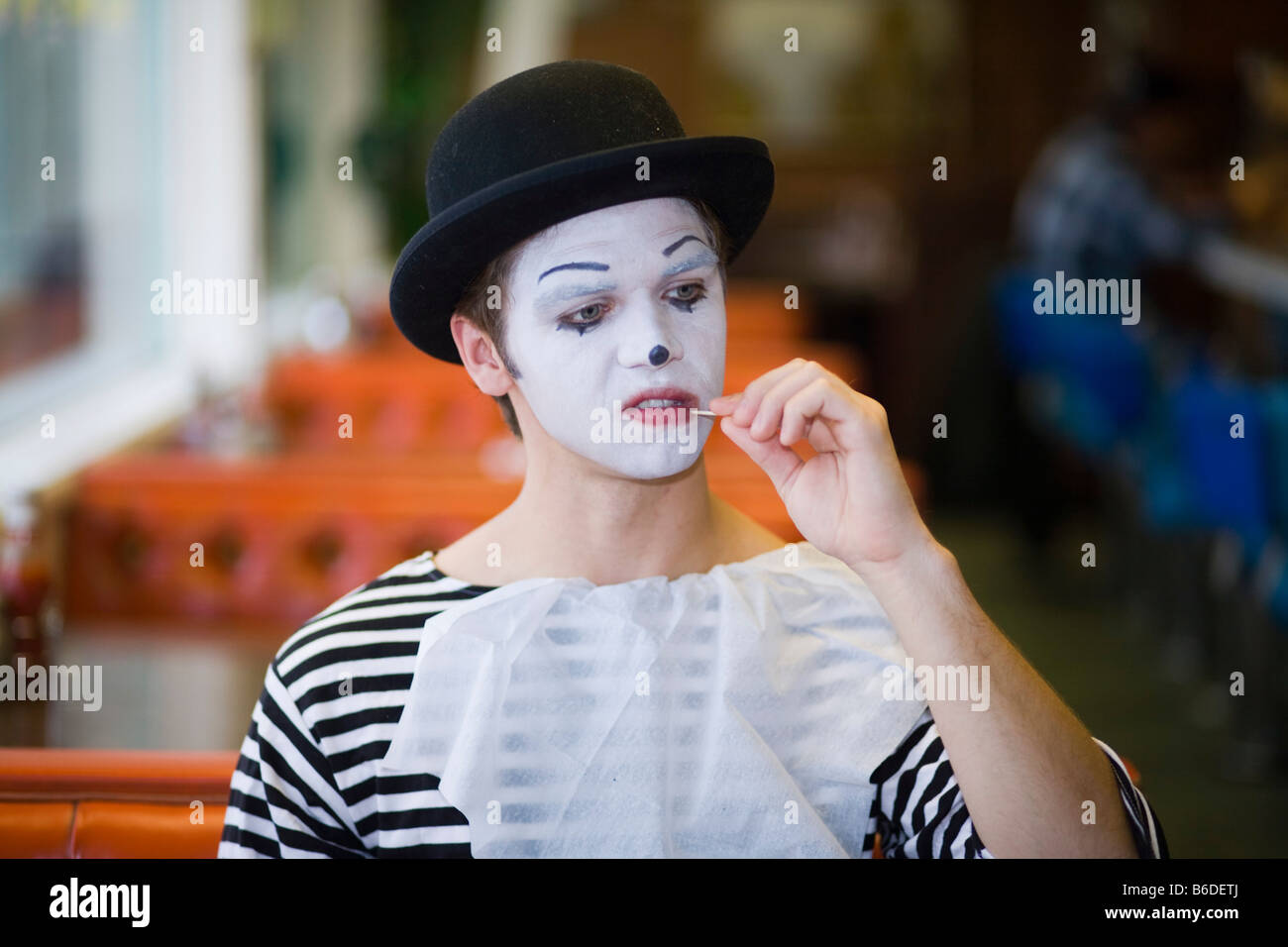 Young man, painted face, mime, smiling Stock Photo - Alamy