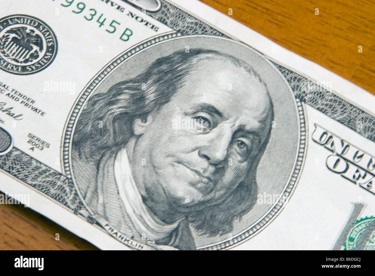 $100 american dollar bill on wooden table Stock Photo - Alamy