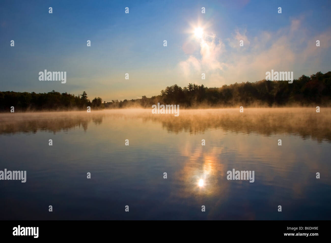 Sunrise with fog over Old Forge Pond in the Adirondack Mountains of New ...