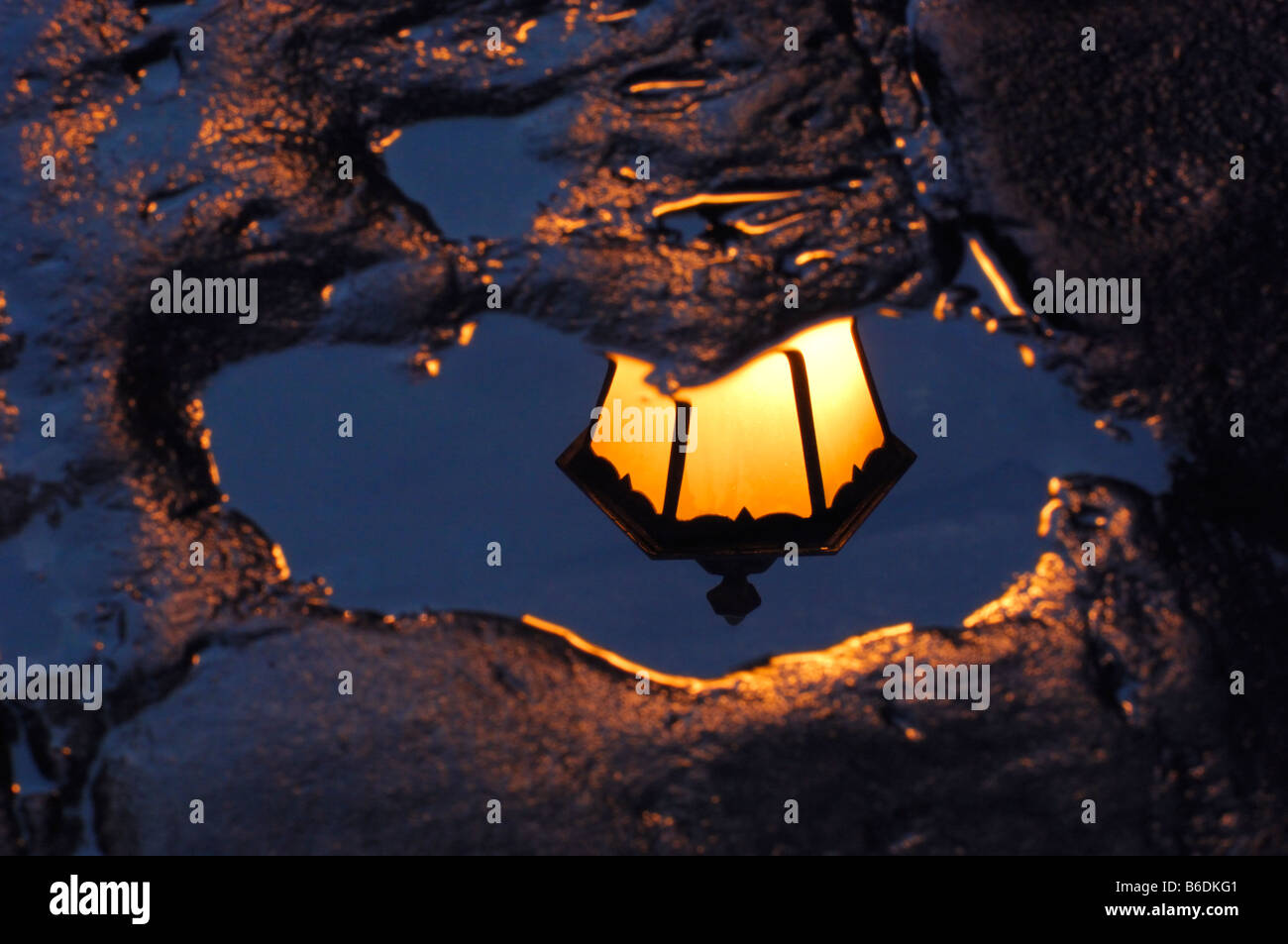 Reflection of street lamp in a puddle after a rainshower, Ciqikou ...