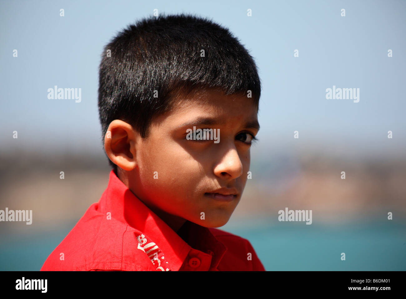 An Indian boy showing serious face Stock Photo - Alamy