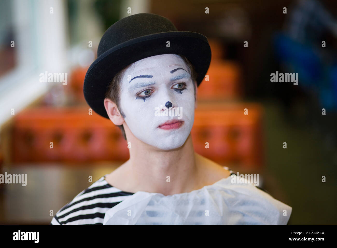 Young man, painted face, mime, smiling Stock Photo - Alamy