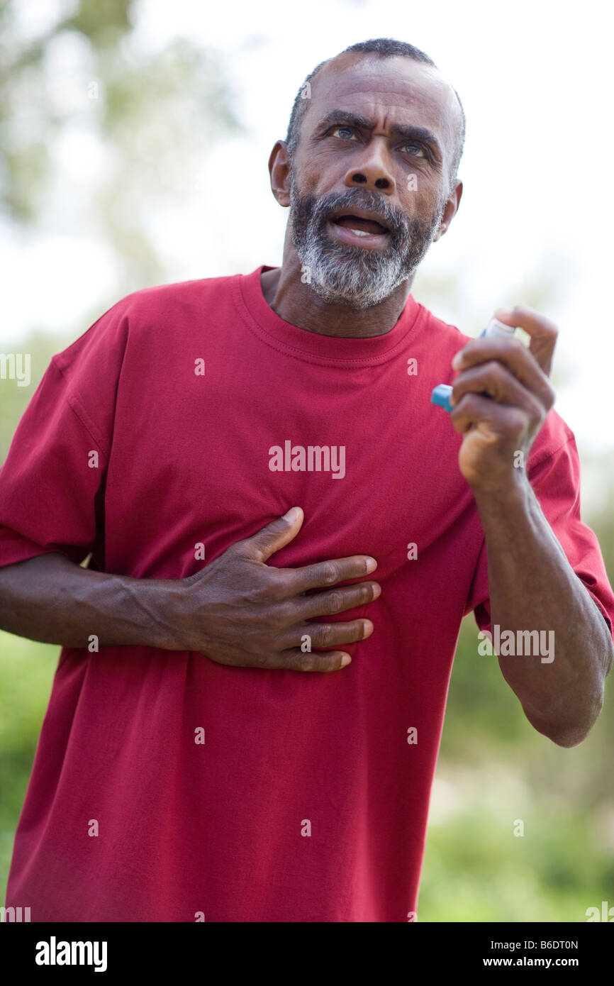 Asthma attack. Elderly man holding his chest as he finds it difficult ... Asthma attack. Elderly man holding his chest as he finds it difficult ...