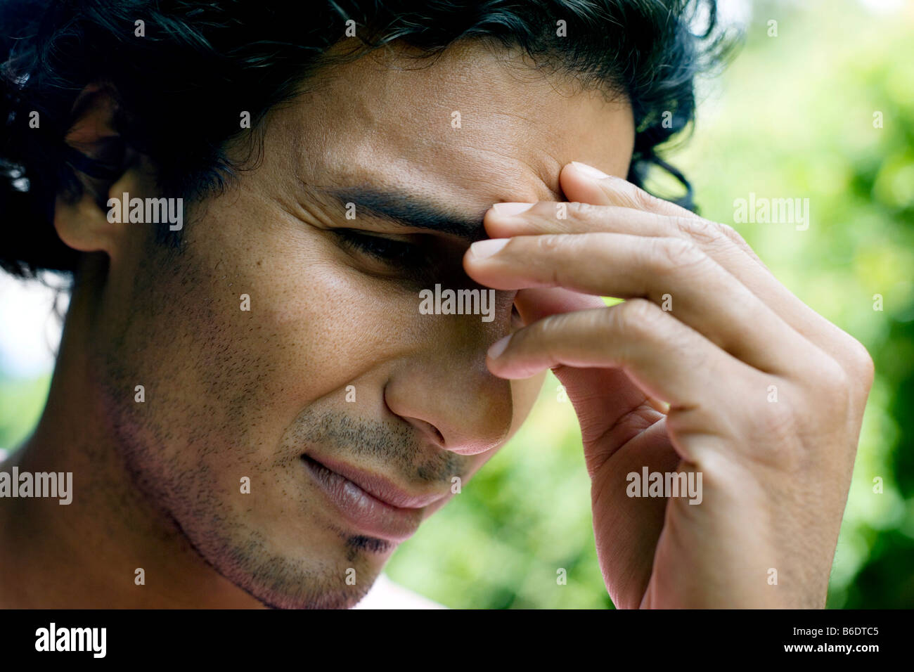 Depression. Unhappy man pressing his hand against his forehead Stock ...