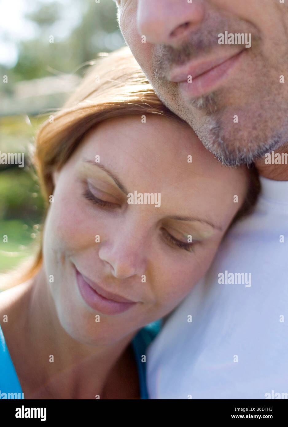 Relationship. Happy woman resting her head on her partner's shoulder ...