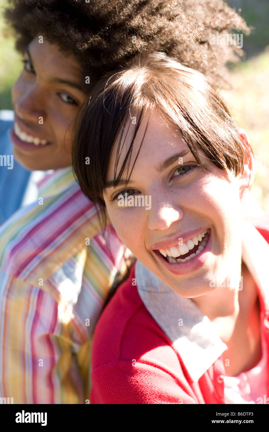Friendship. Woman leaning against her friend's back Stock Photo - Alamy