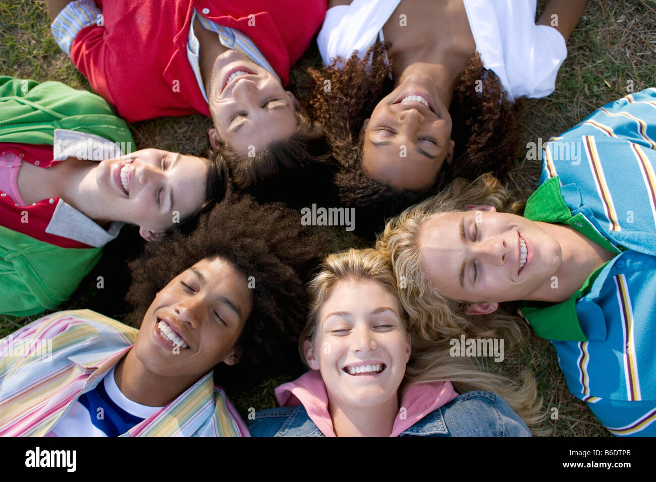 Group of friends lying down in a circle Stock Photo - Alamy