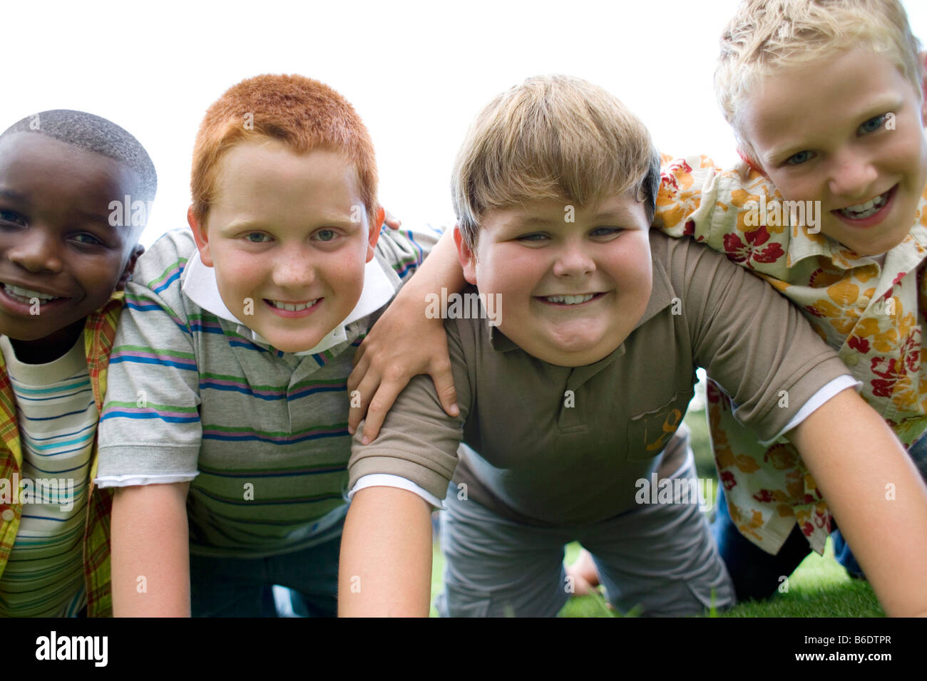 Friendship. Group of boys playing on their hands and knees Stock Photo ...
