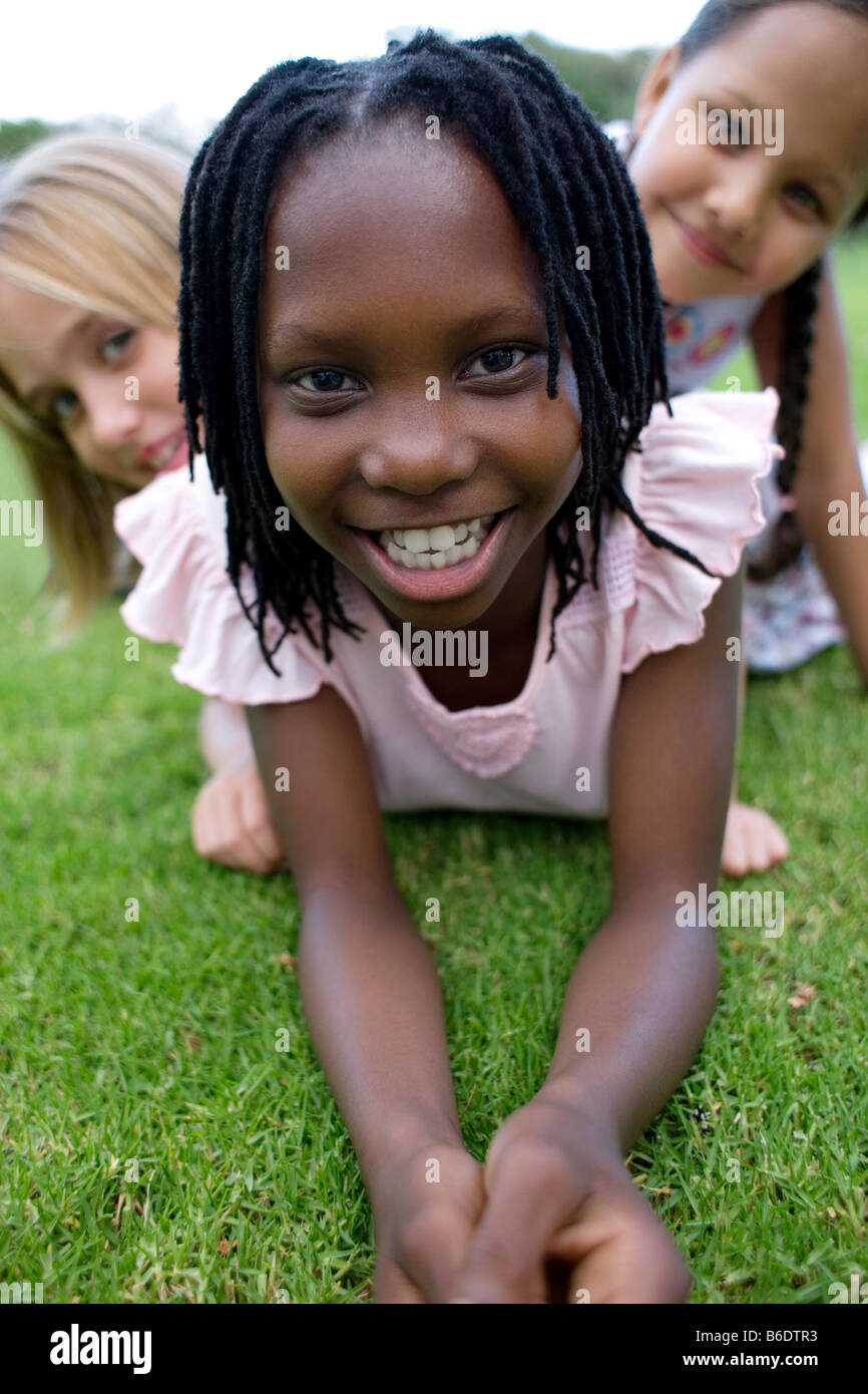 Friendship. Three girls on grass Stock Photo - Alamy