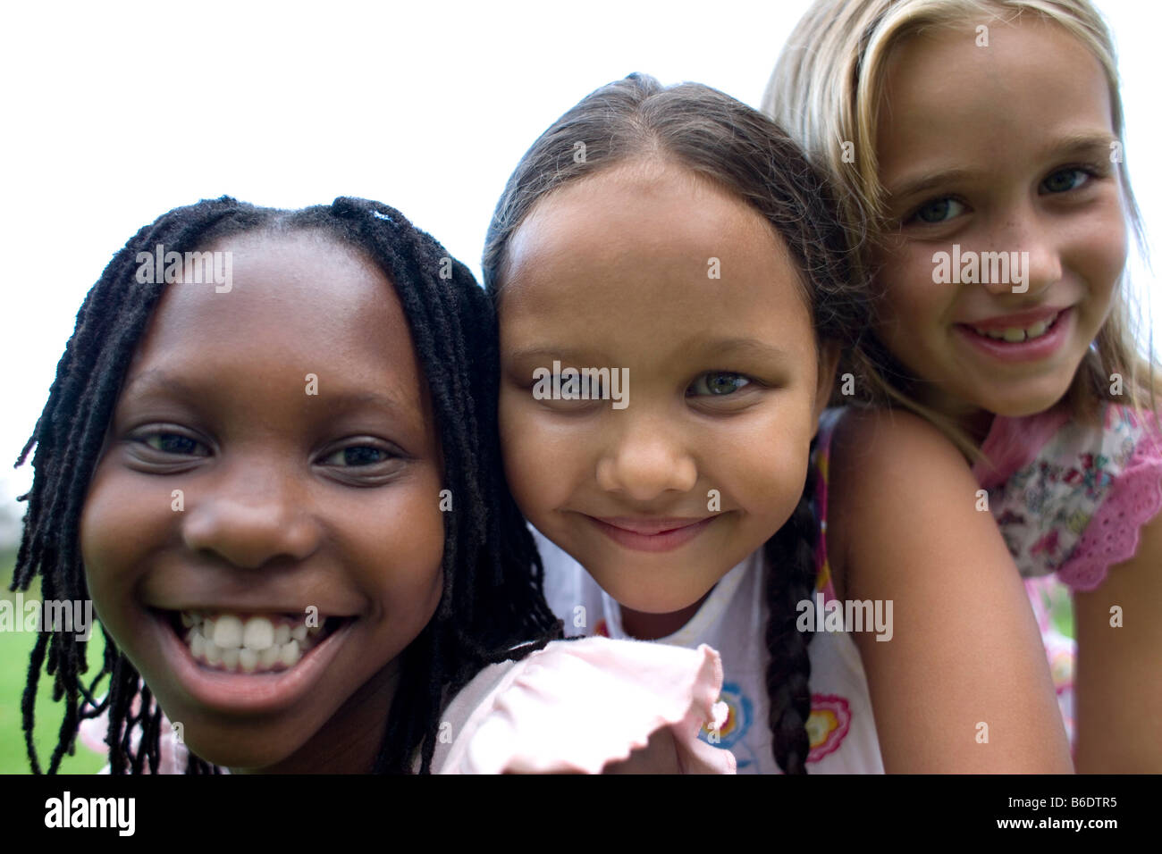 Friendship. Three girls huddled together Stock Photo - Alamy