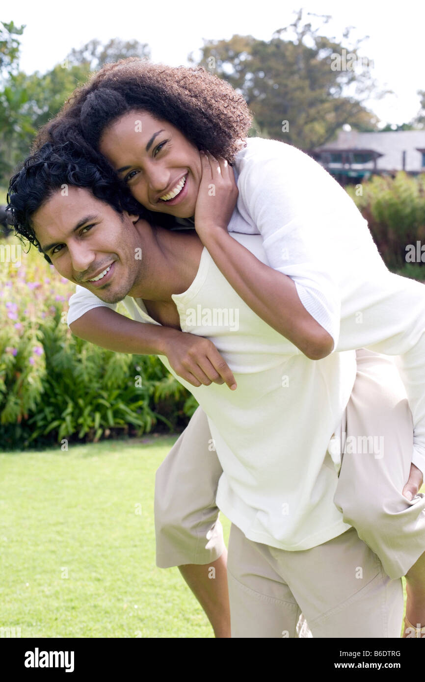 Happy couple. Woman being carried on her partner's back Stock Photo - Alamy