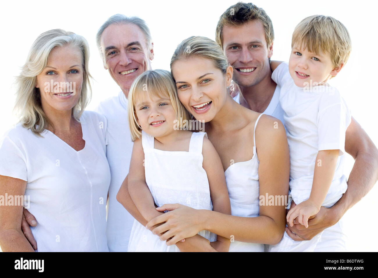 Happy family embracing, smiling Stock Photo - Alamy