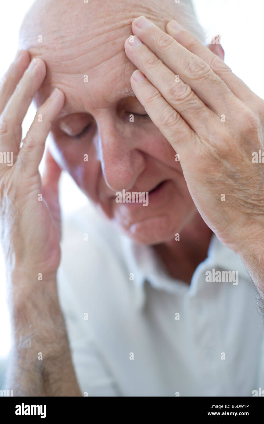 Man pressing her aching temples Stock Photo - Alamy