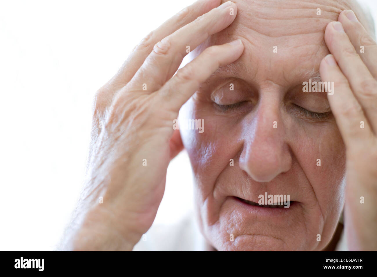 Man pressing her aching temples Stock Photo - Alamy