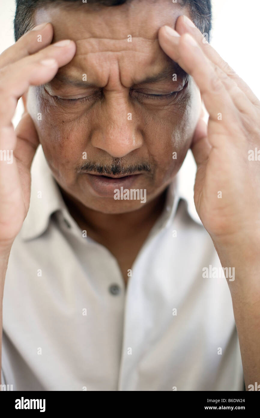 Man pressing her aching temples Stock Photo - Alamy