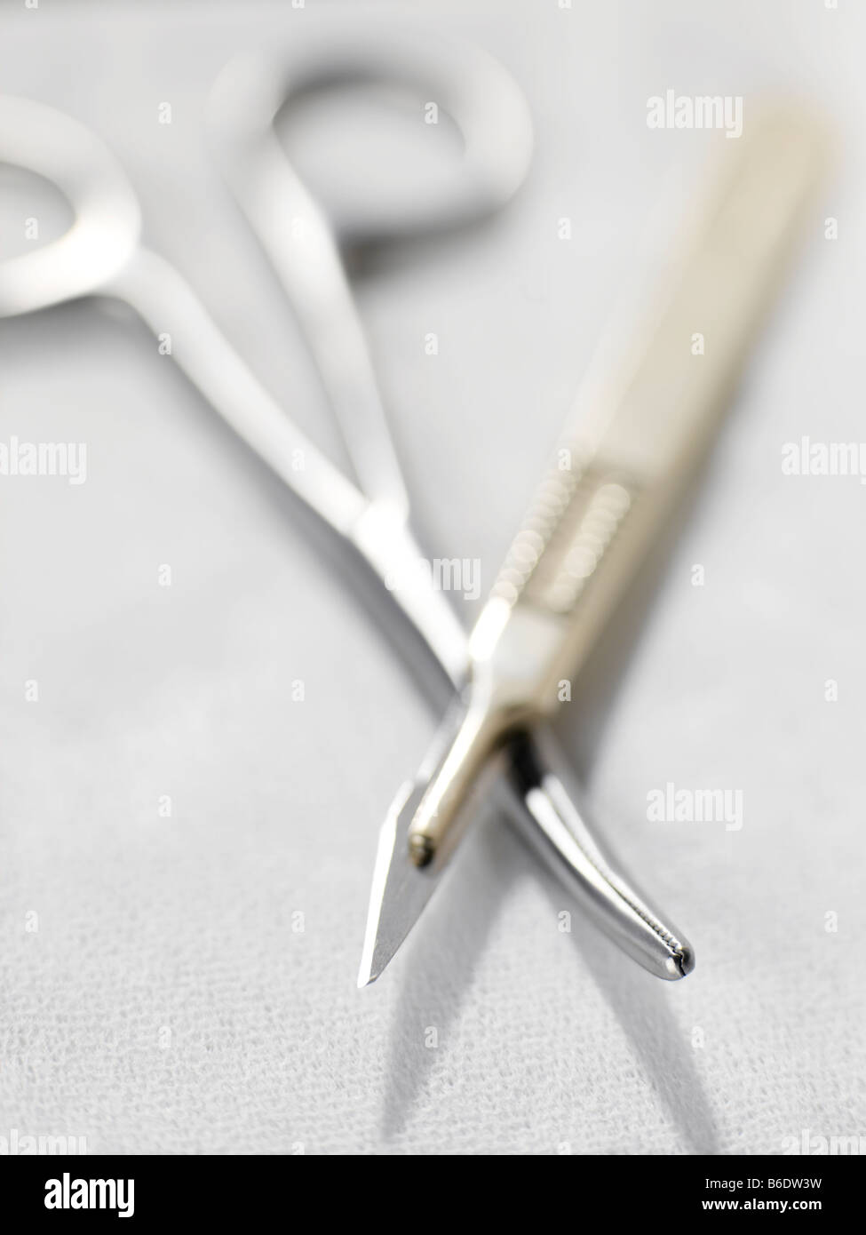 Surgical tools. Scalpel and a pair of forceps Stock Photo - Alamy