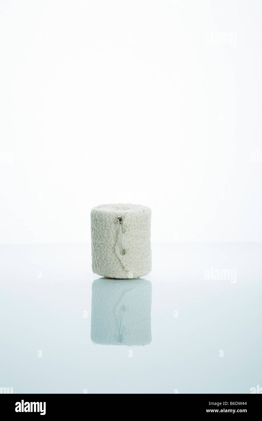 Bandage rolled up with a safety pin Stock Photo - Alamy