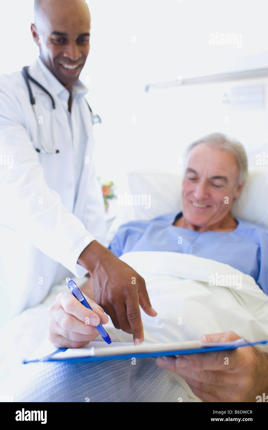 Doctor and patient. Patient signing medical forms before surgery Stock ...