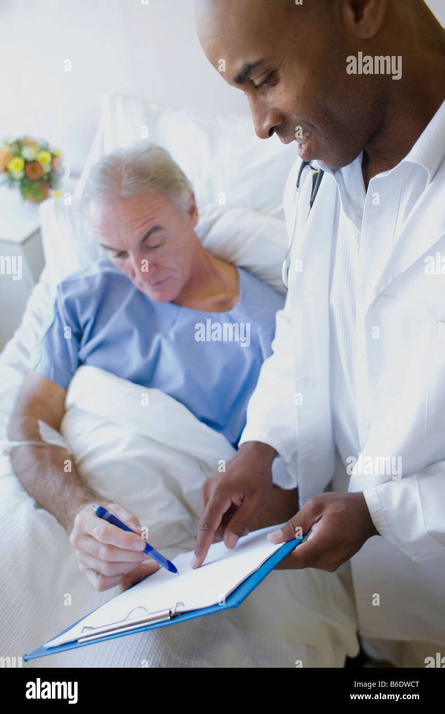 Doctor and patient. Patient signing medical forms before surgery Stock ...