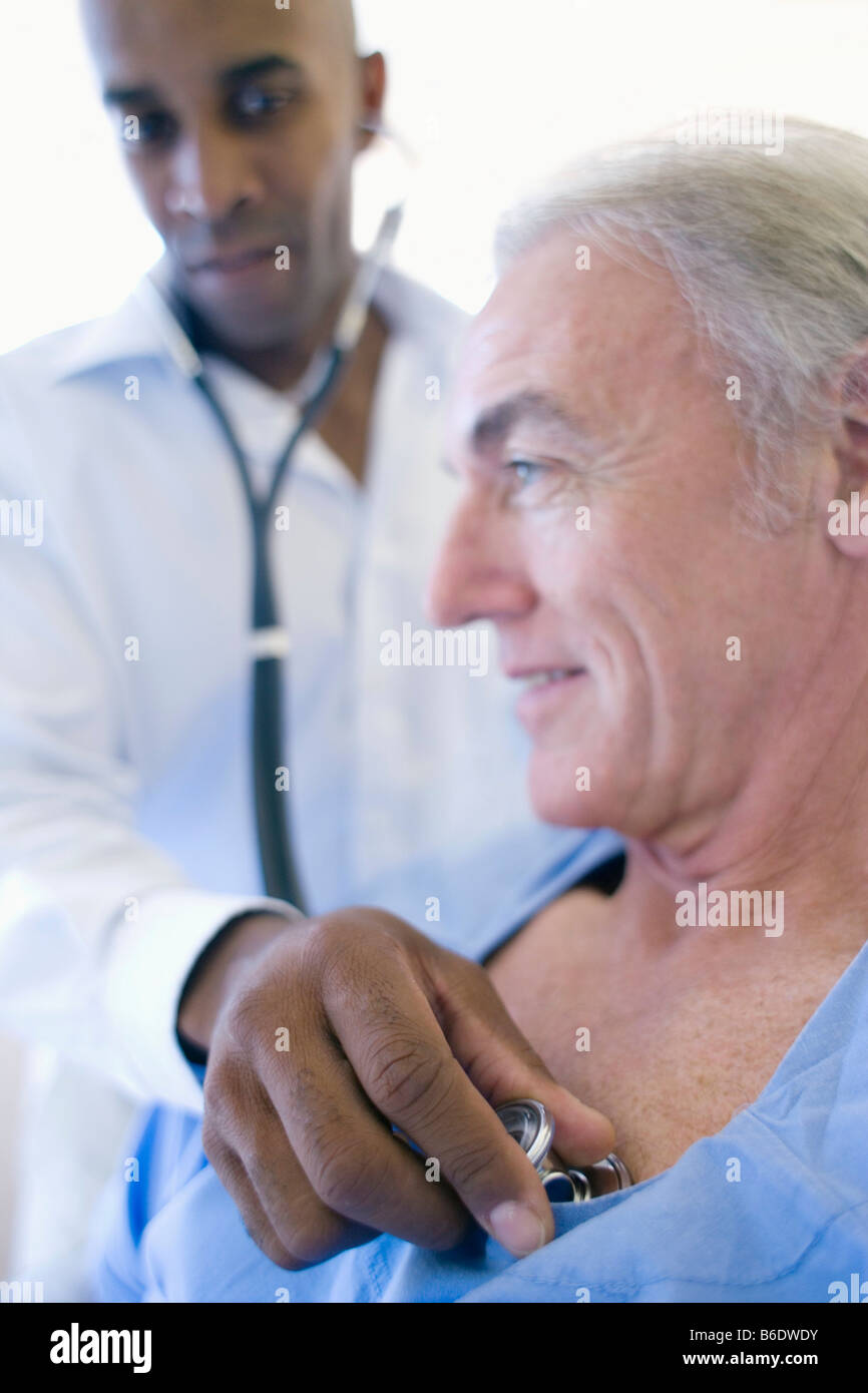 Doctor listening male patients chest hi-res stock photography and ...