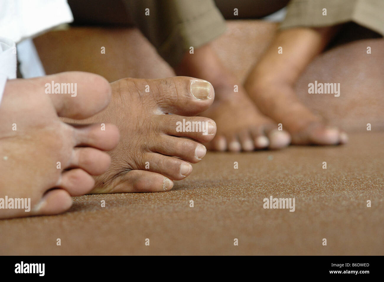Selective Focus Photograph of the Bare Feet of Three People Praying at ...