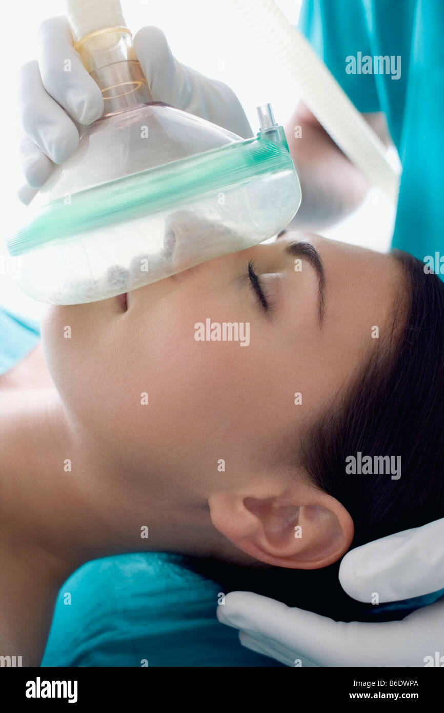 Anaesthesia. Anaesthetist administering gas to a patient. The gas is a ...