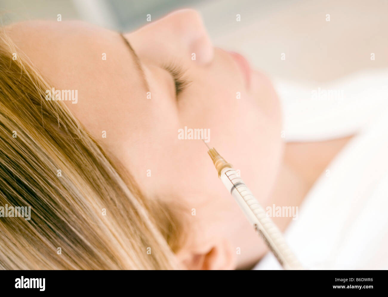 Botox treatment. Client having botox injected into her face. Botox is a ...