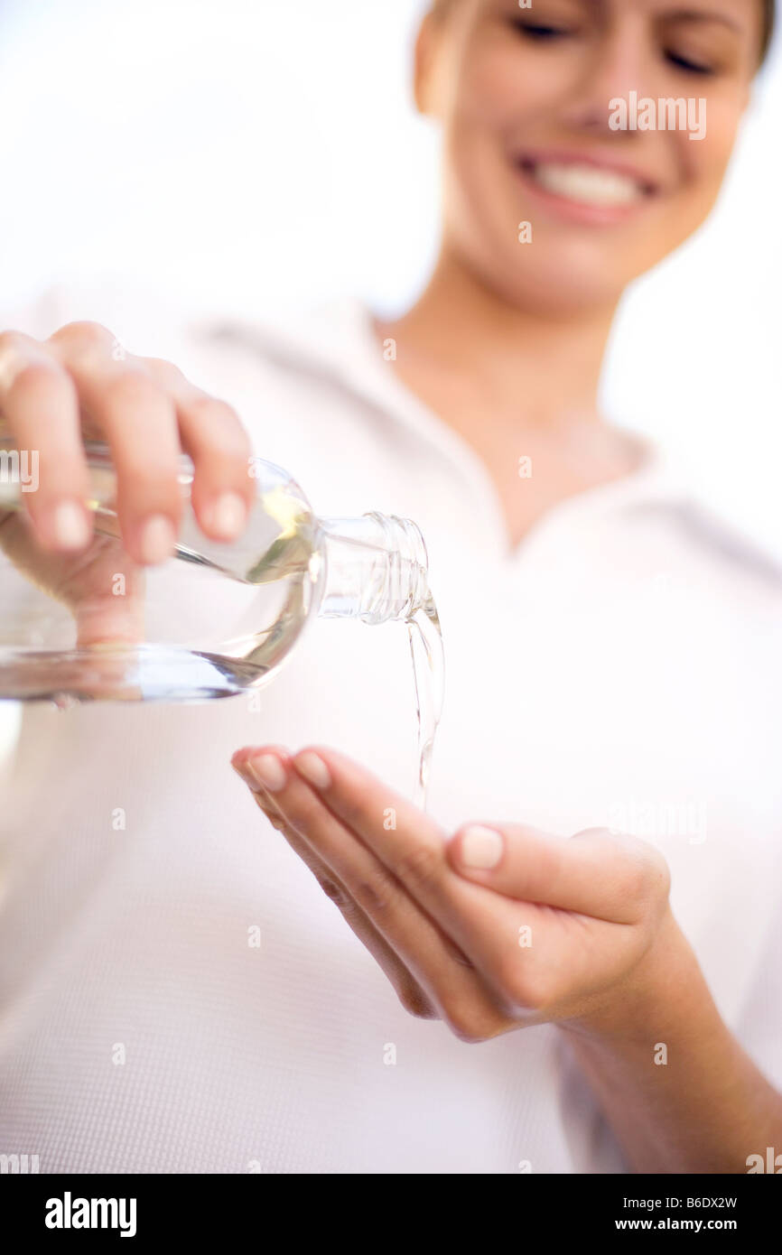 Woman pouring oil on hands hi-res stock photography and images - Alamy
