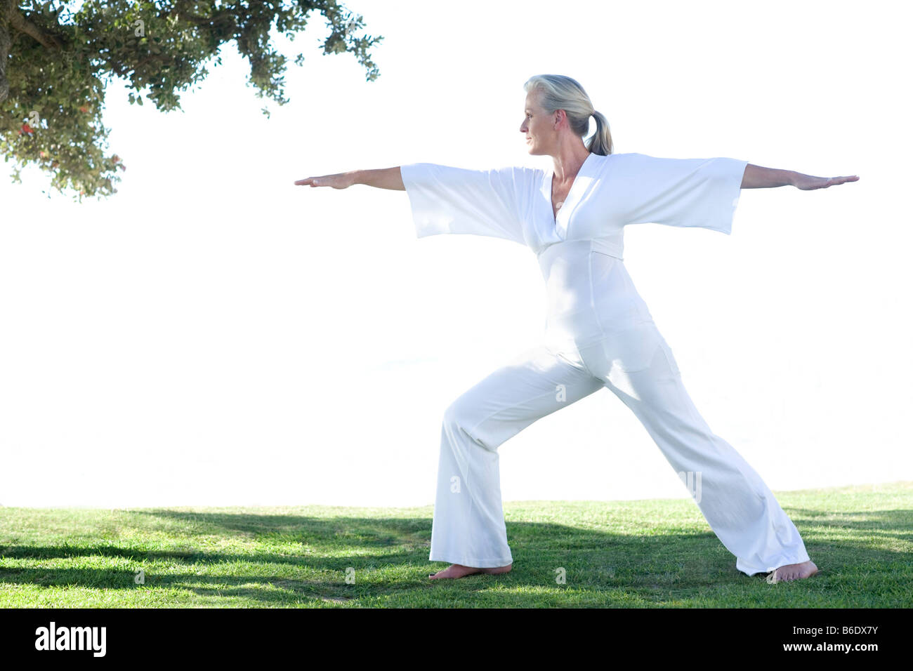 Senior woman performing yoga exericse Stock Photo - Alamy