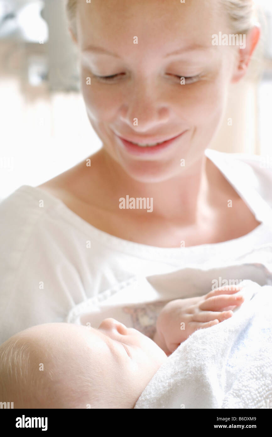 Mother and newborn baby. Woman in a maternity ward holding her newborn ...