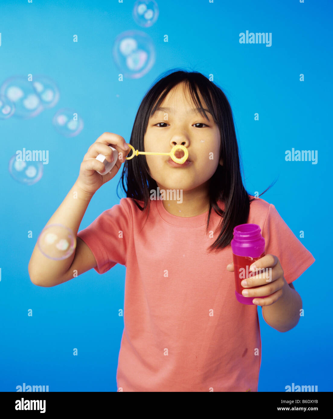 Blowing bubbles.6-year-old girl blowing soap bubbles from a wand Stock ...