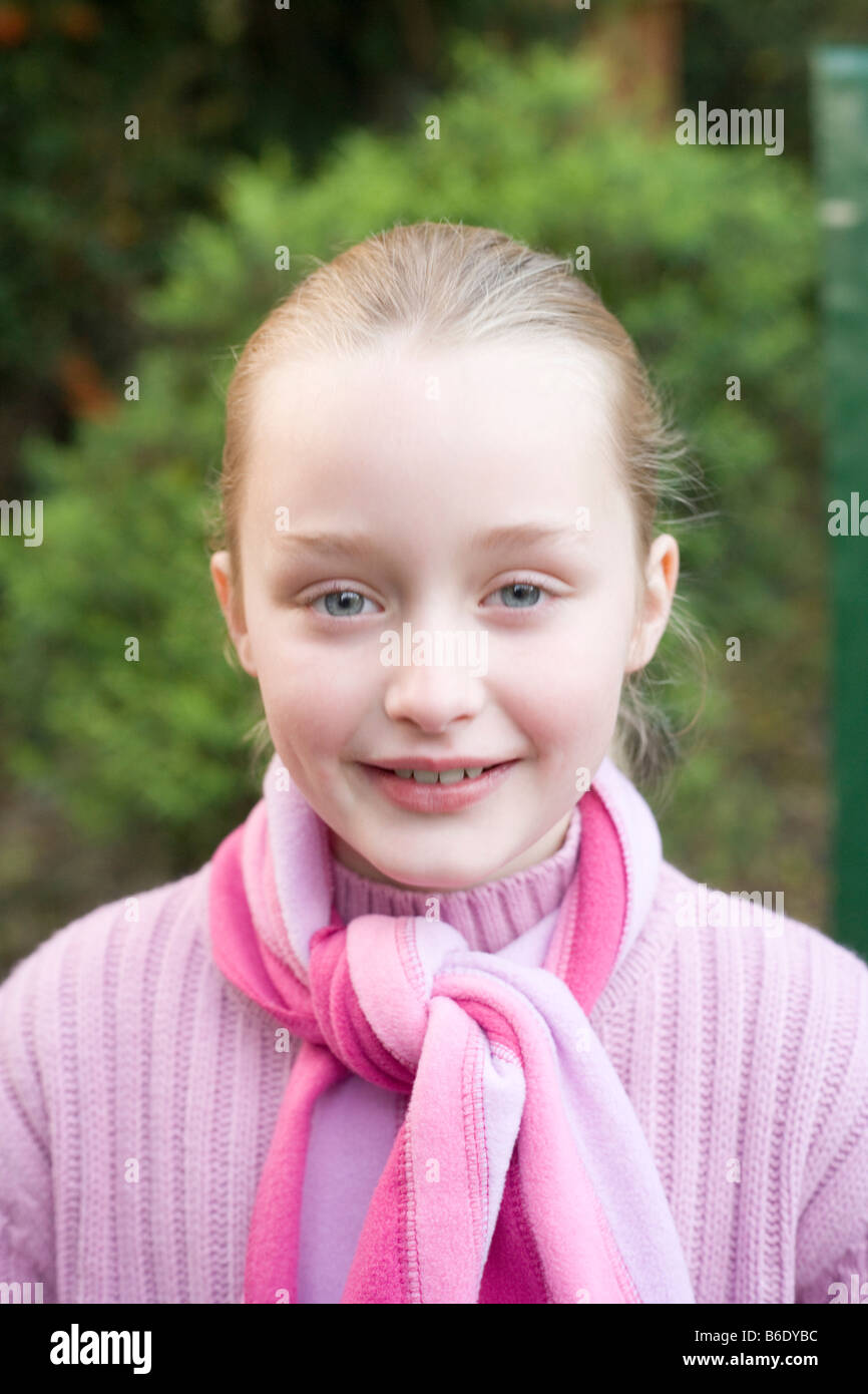 Smiling girl standing outdoors and wearing a scarf Stock Photo - Alamy