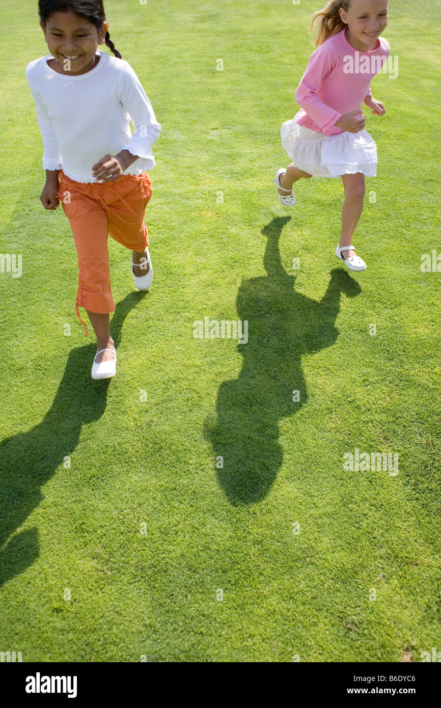 Girls playing on grass Stock Photo - Alamy