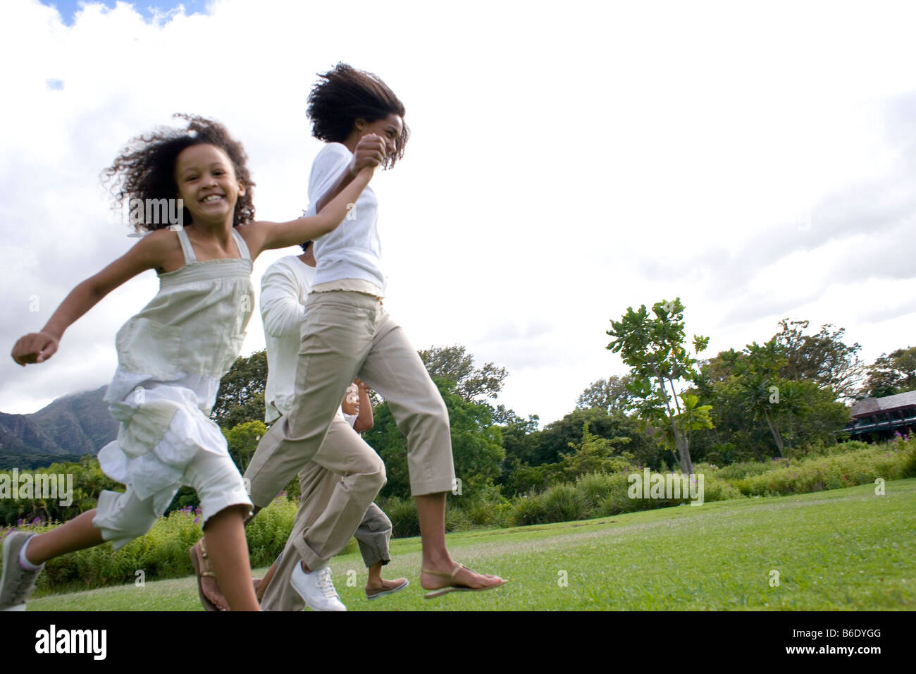 Happy family. Parents running with their two children in the ...