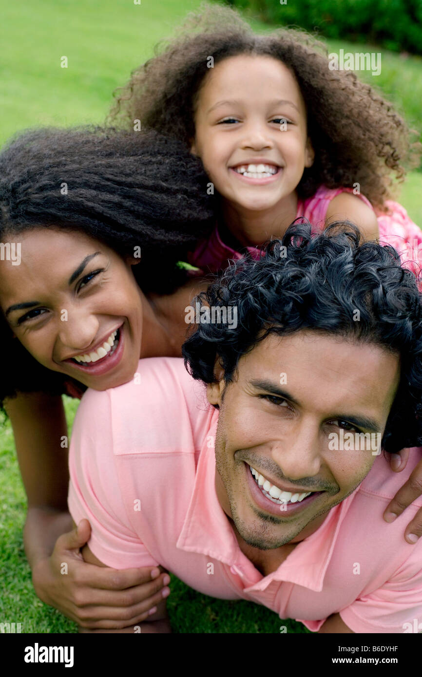 Happy family. Parents with their daughter on the grass Stock Photo - Alamy